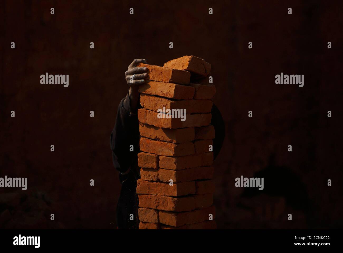 Man carrying heavy brick hi-res stock photography and images - Alamy