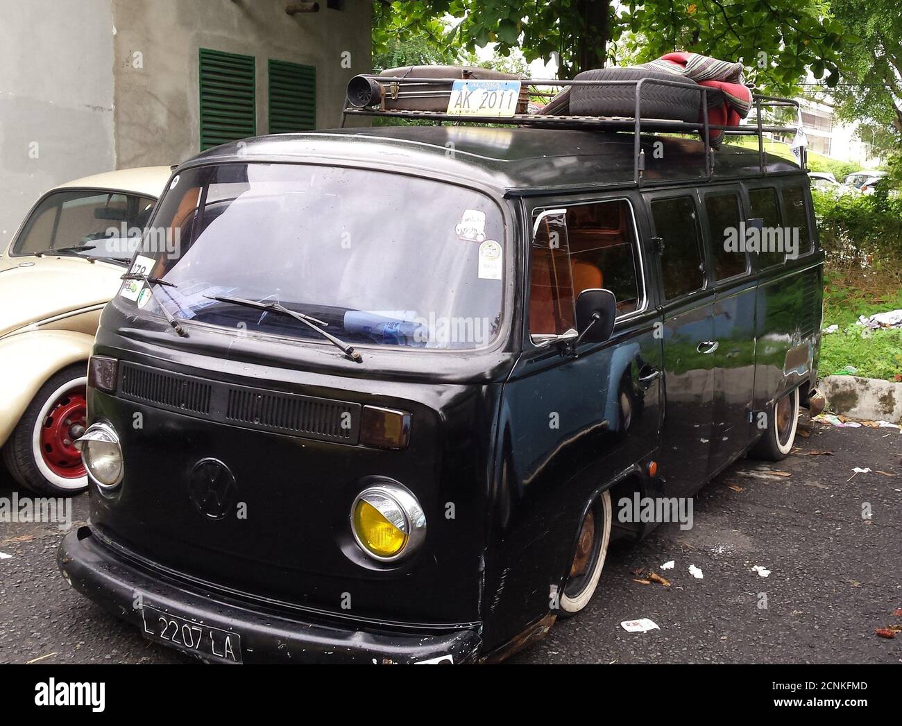 Full length front view from one black VW Bulli, VW Combi in parking lot ...
