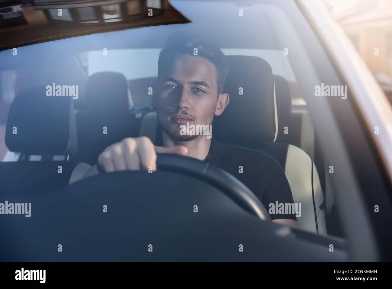 Portrait of an handsome guy driving his car Stock Photo - Alamy