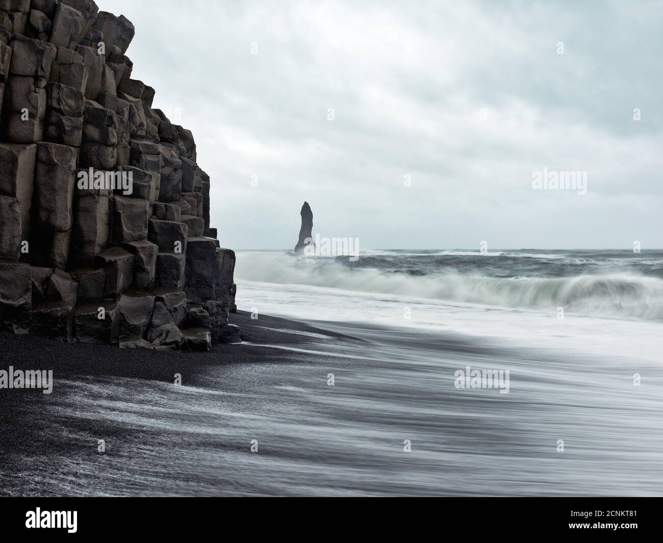 Basalt columns, basalt cliffs, rock needle, surf, waves, coast, shore ...