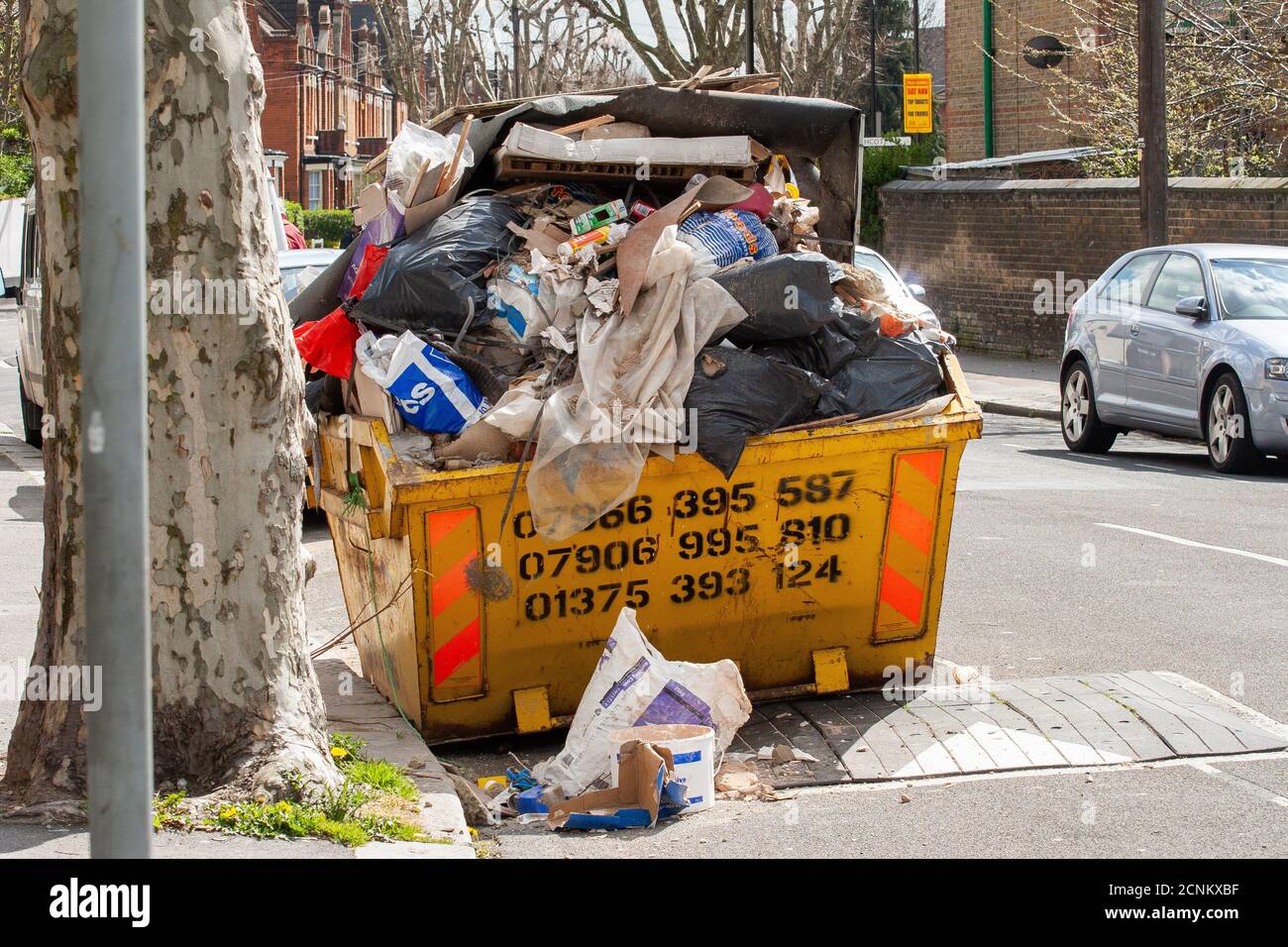 Overflowing rubbish skip hi-res stock photography and images - Alamy