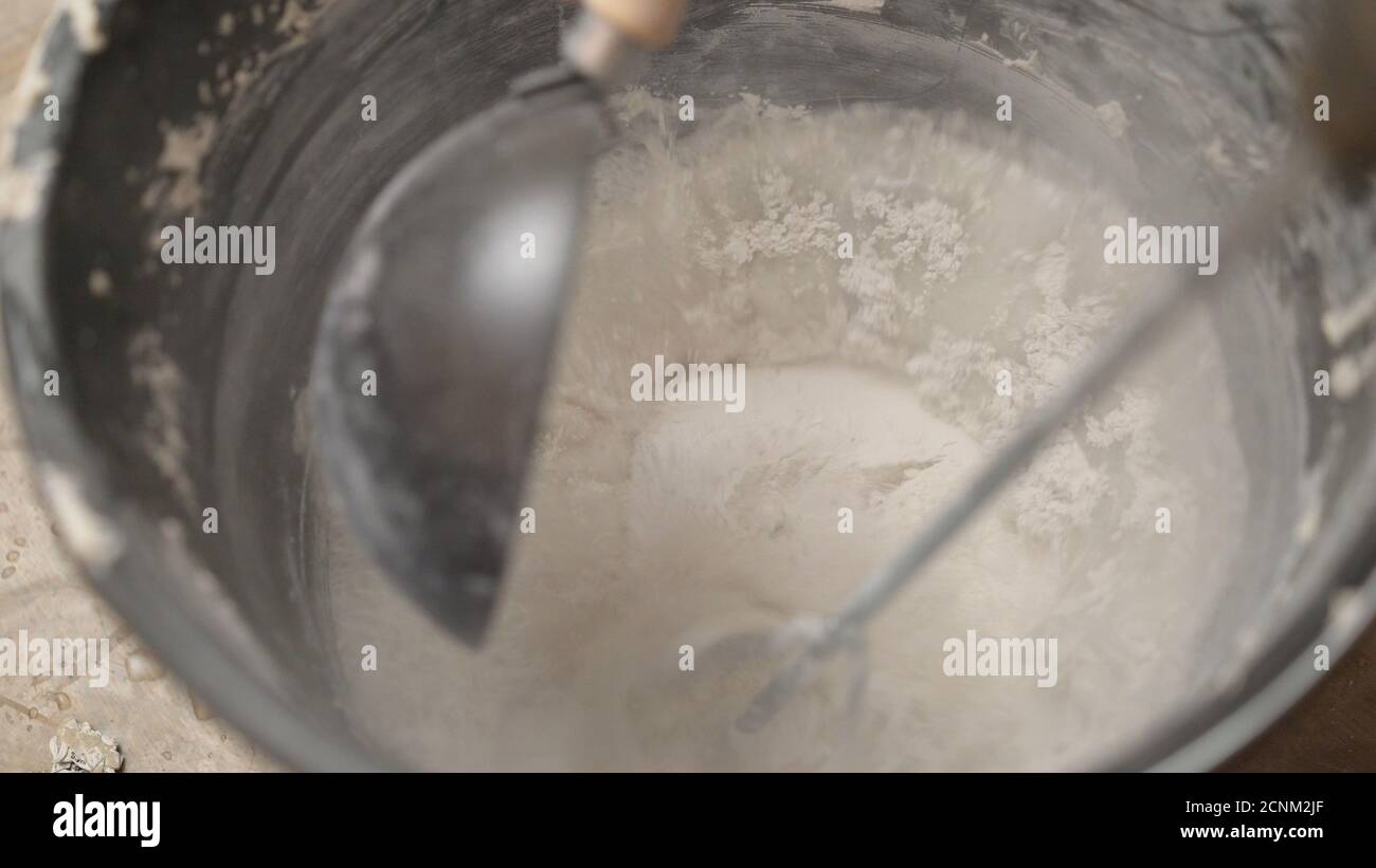 Mix the solution in a bucket using a construction mixer. Worker mixing ...