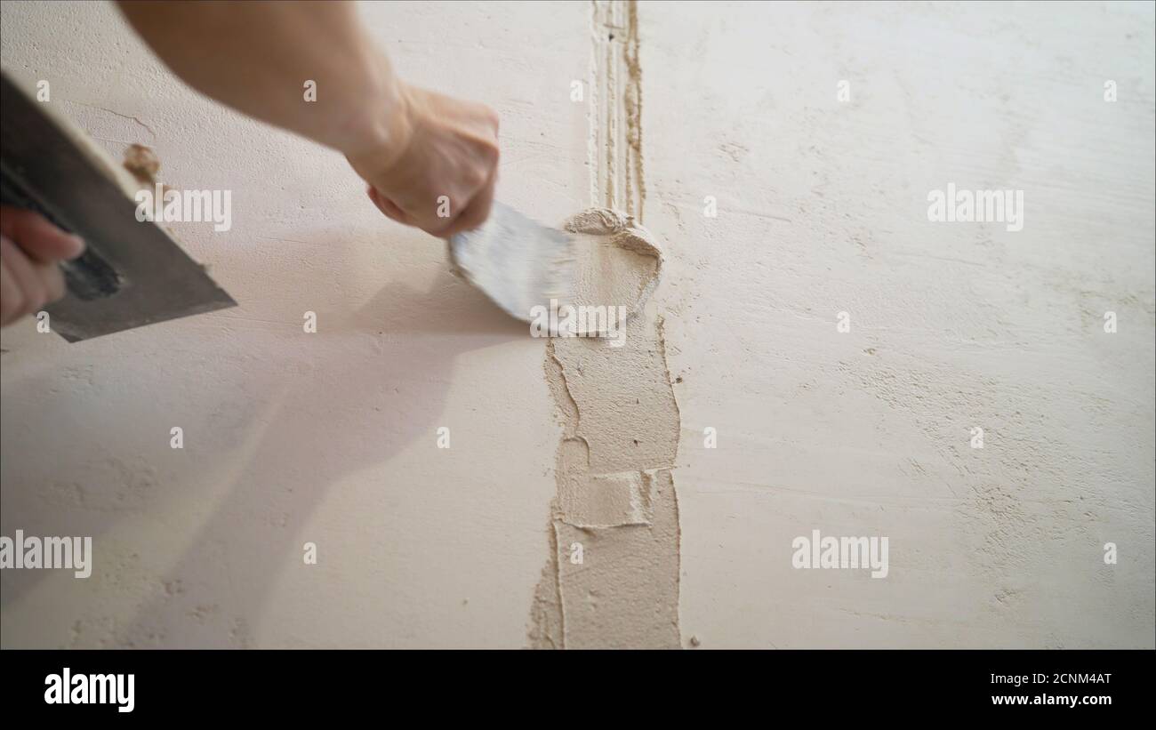 Plastering the wall. Hands Plasterer at work. Application of the ...