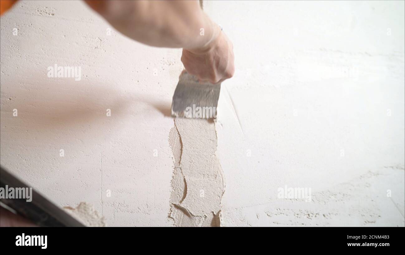 Plasterer putting plaster on wall. Worker covers the wall with mortar ...