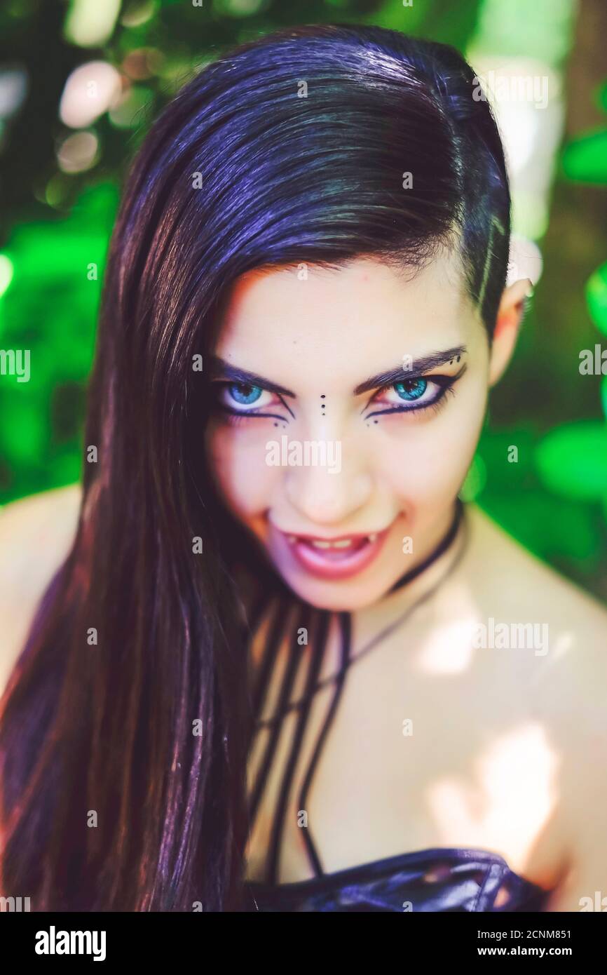 portrait of demonic makeup girl with vampire teeth. High quality photo ...