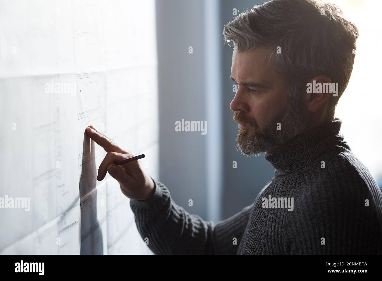 Close-up portrait of handsome man concentrated on work. Architect ...