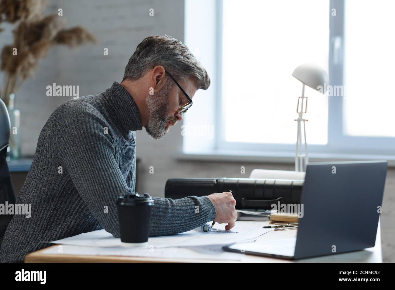 Interior designer working in office with blueprints.Engineer inspect ...