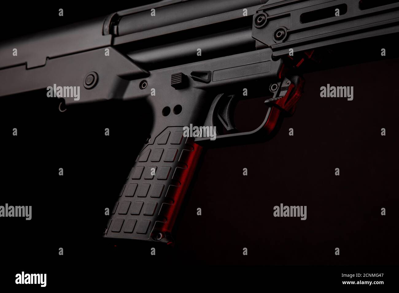Close up of a modern tactical pump action shotgun against a dark ...