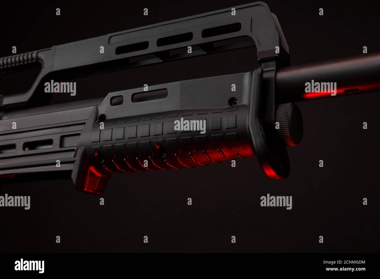 Close up of a modern tactical pump action shotgun against a dark ...