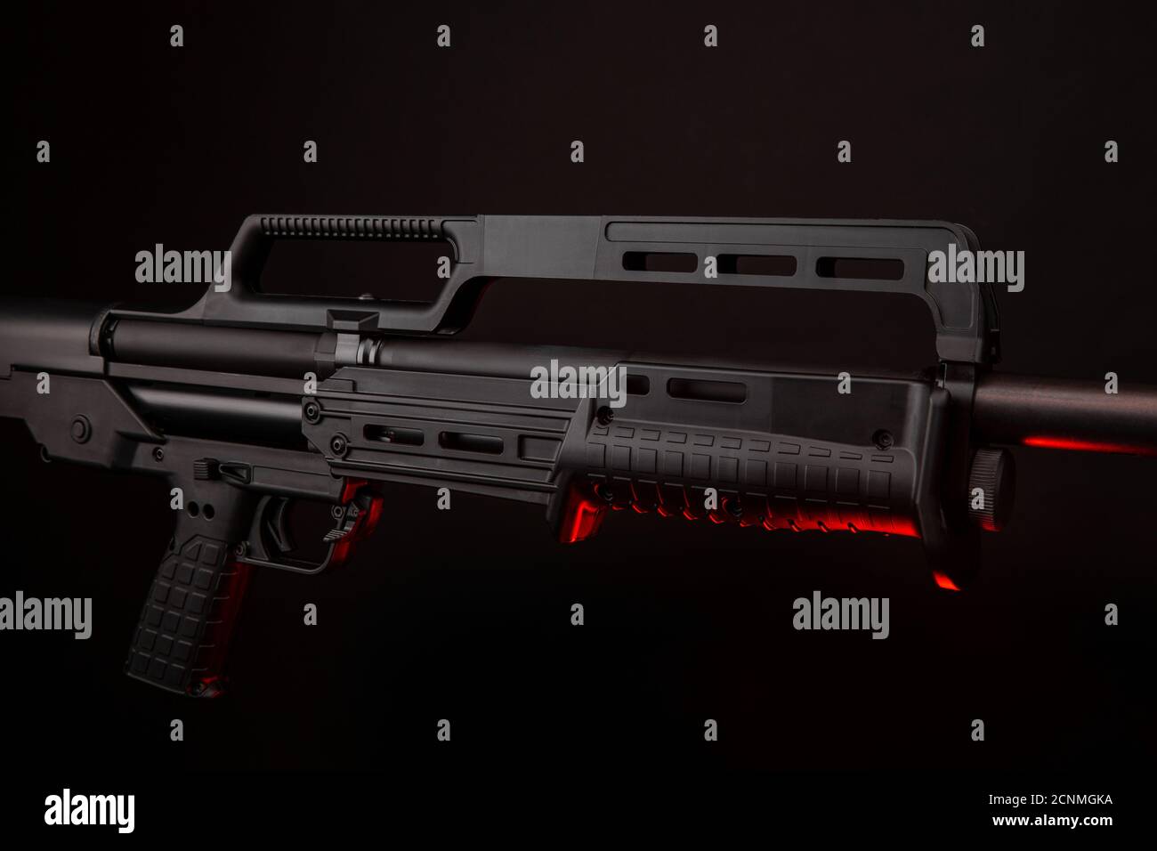 Close up of a modern tactical pump action shotgun against a dark ...