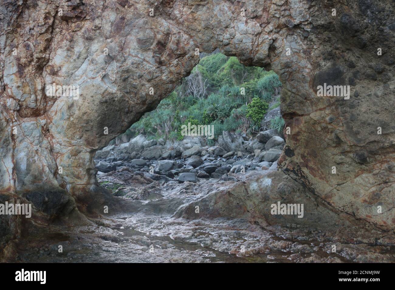 Frame view through a hole in a rock at a coast Stock Photo - Alamy