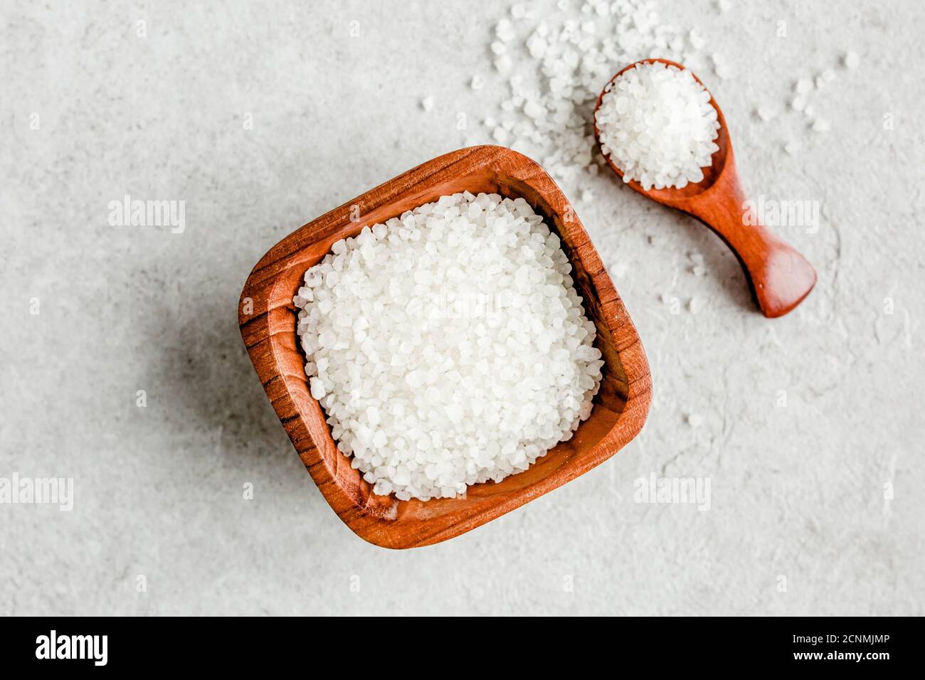 Salt in wooden bowl with scoop on gray stone table. Sea salt flat lay ...