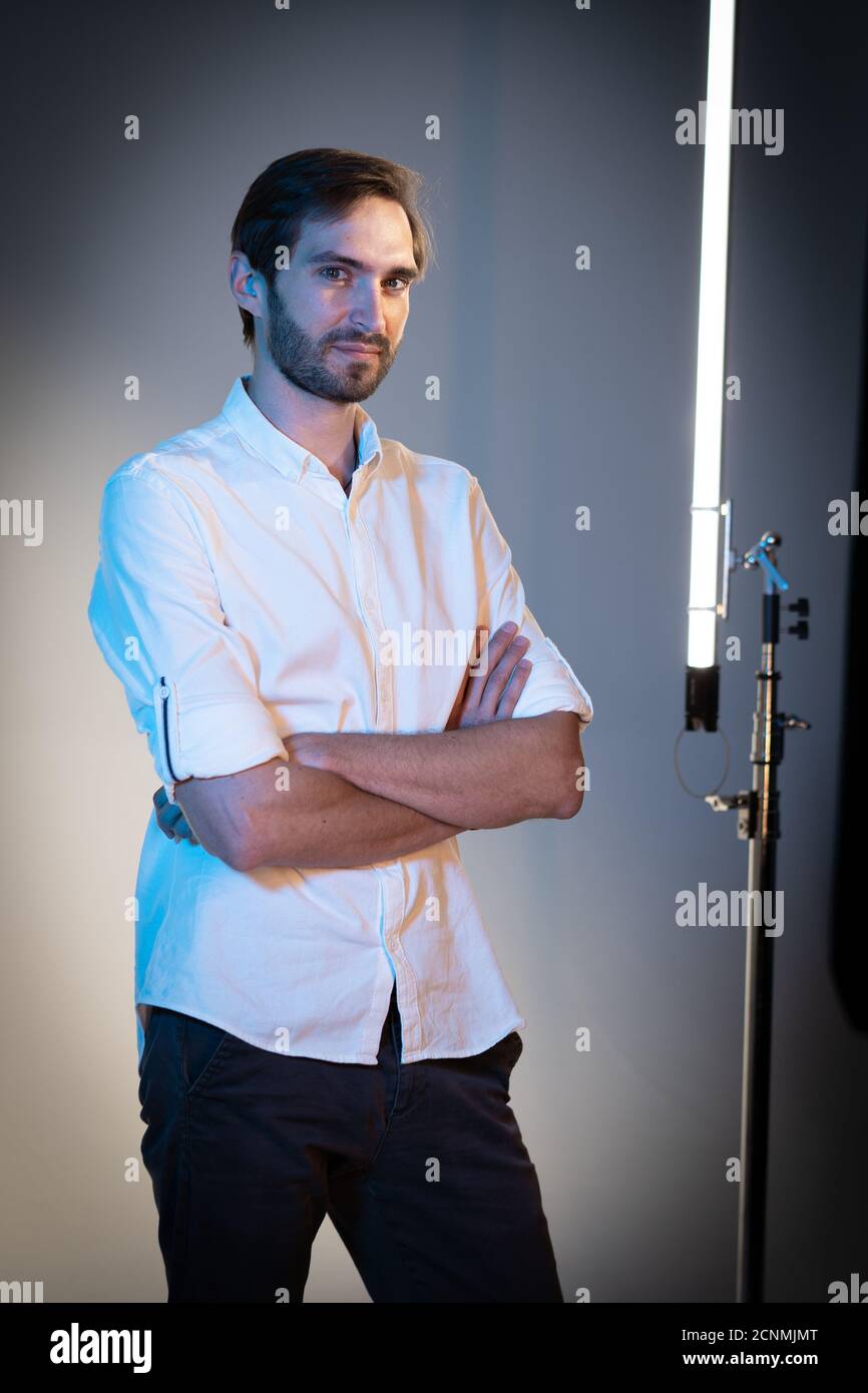 Handsome man crosed arms posing on white background among studio ...