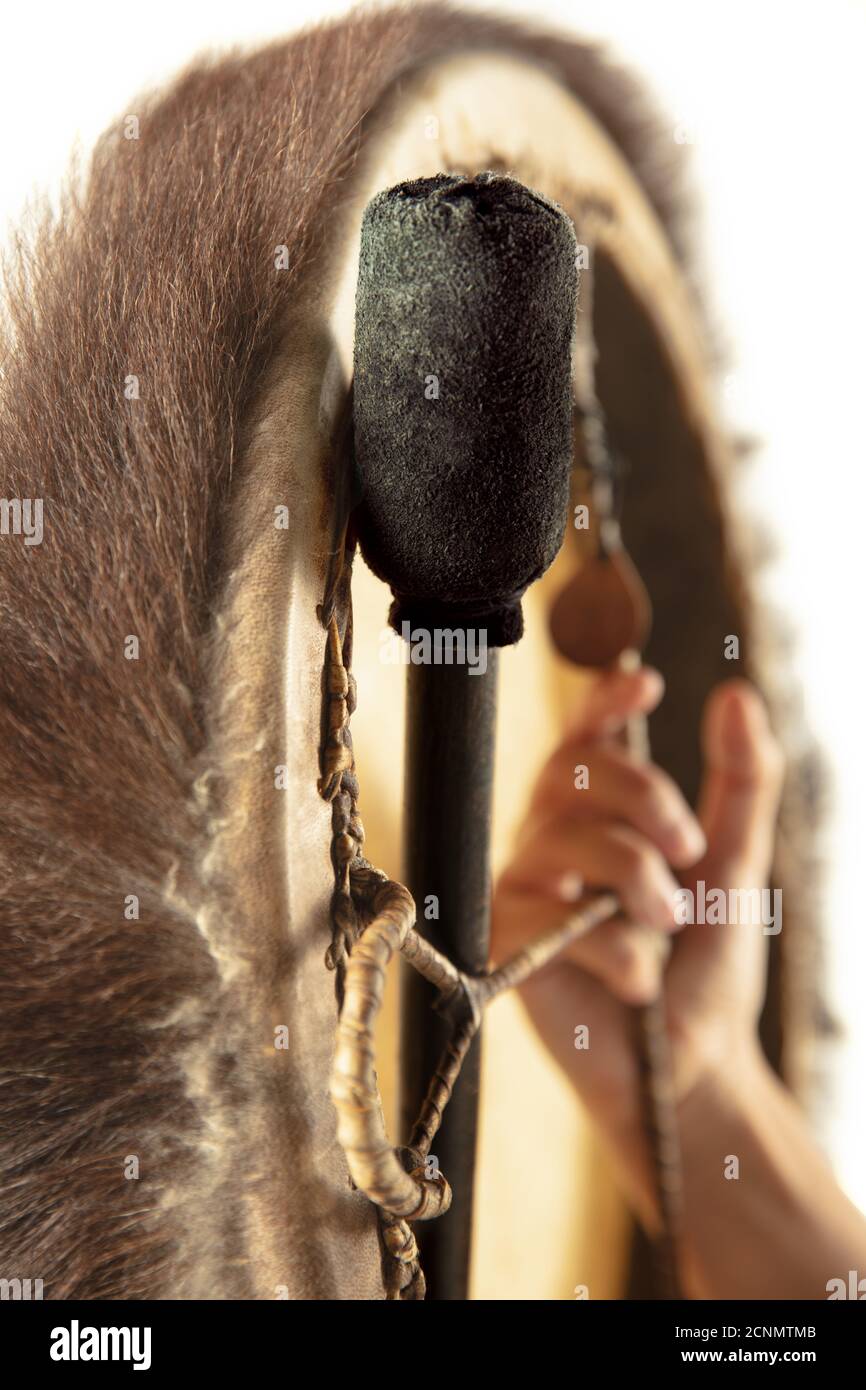 A close up of hands playing the tambourine, percussion on white studio ...