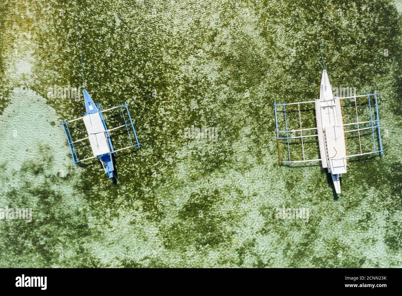 Top down aerial view of a two tourist boats over a tropical coral reef ...