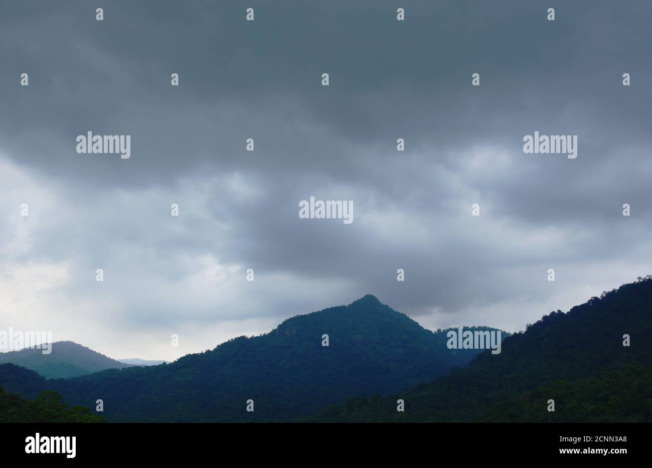 Rain cloud floating over mountain on river Stock Photo - Alamy
