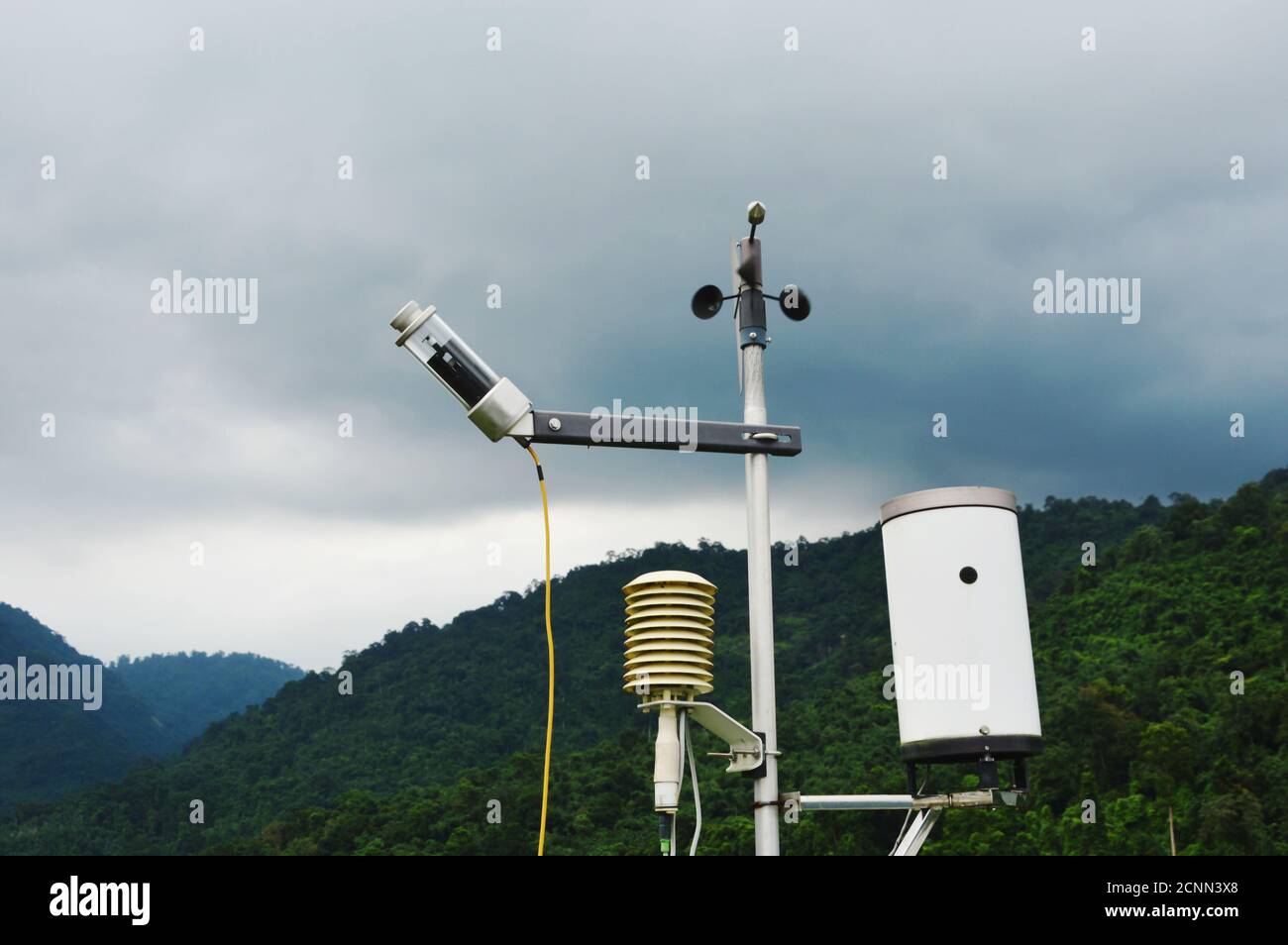 Pluviometer or rain gauge in mountain background with rain cloud on sky ...