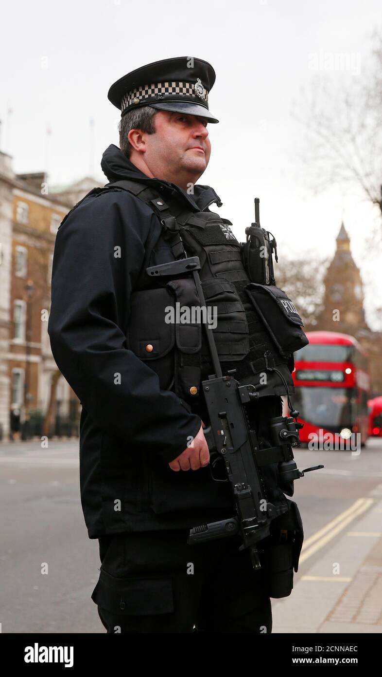 An armed police officer stands hi-res stock photography and images - Alamy