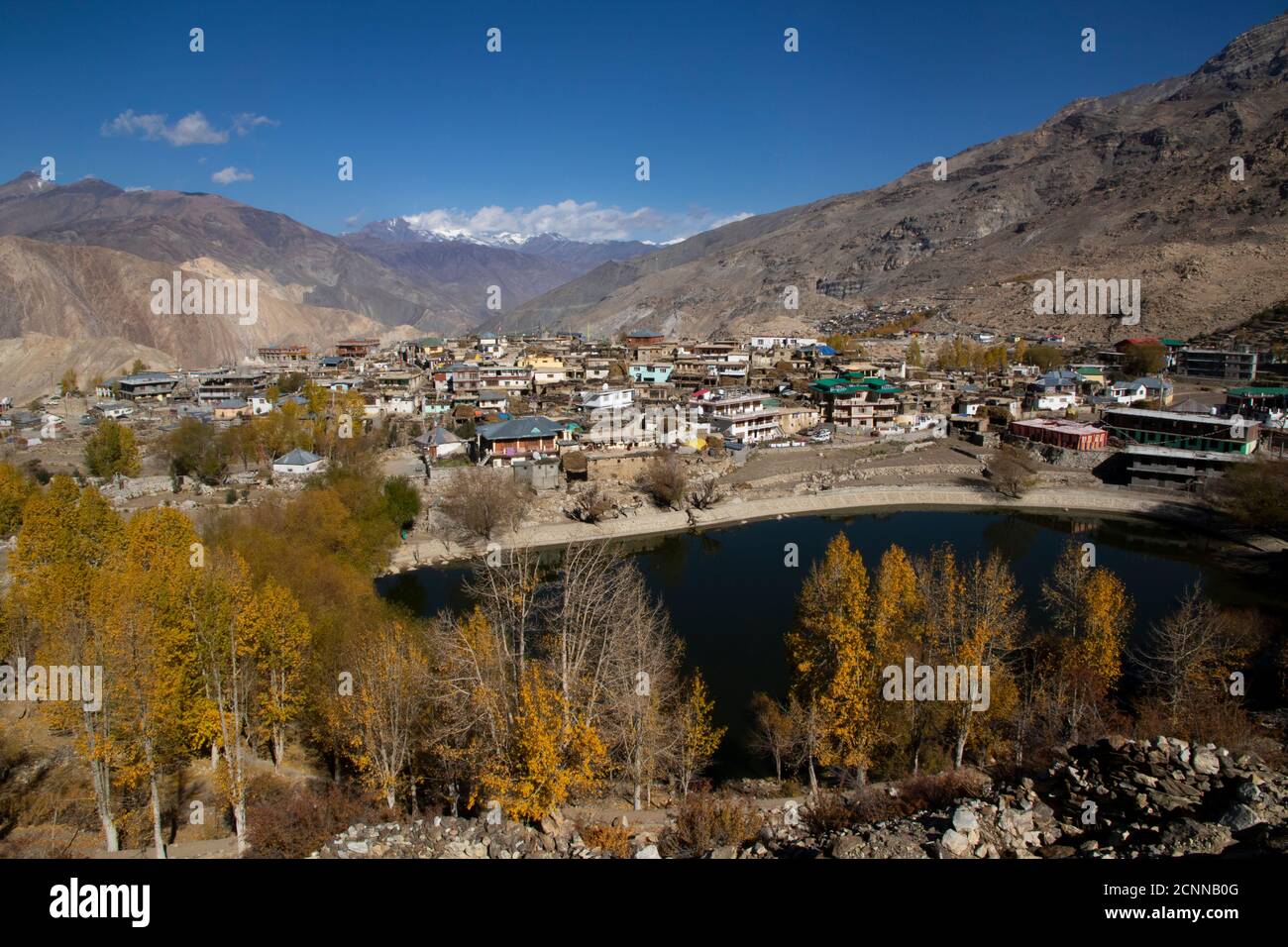 Photographer and a model hike to a hilltop on a clear day with the ...