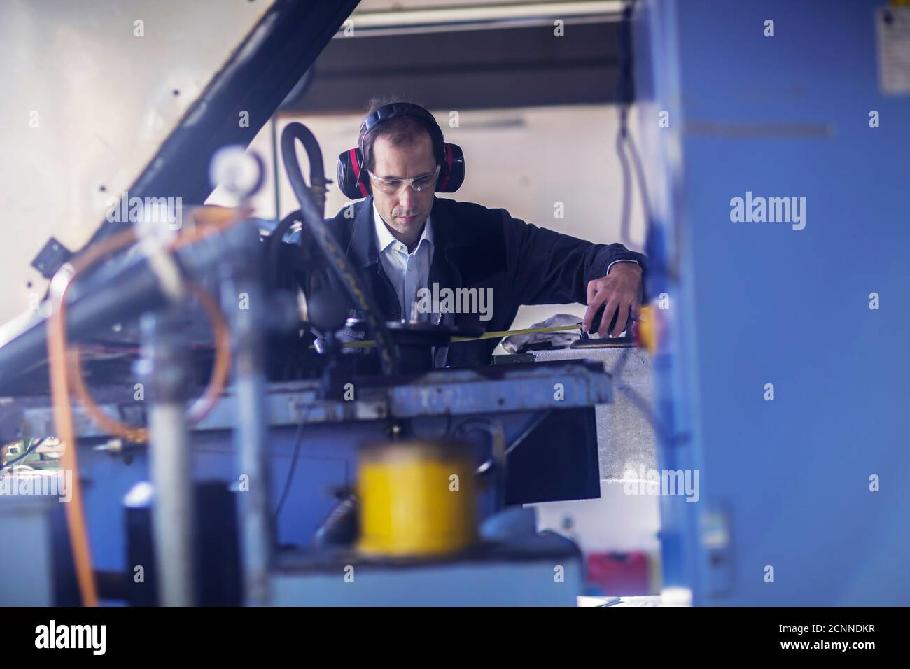 Engineer checking equipment at an industrial plant, Germany Stock Photo ...