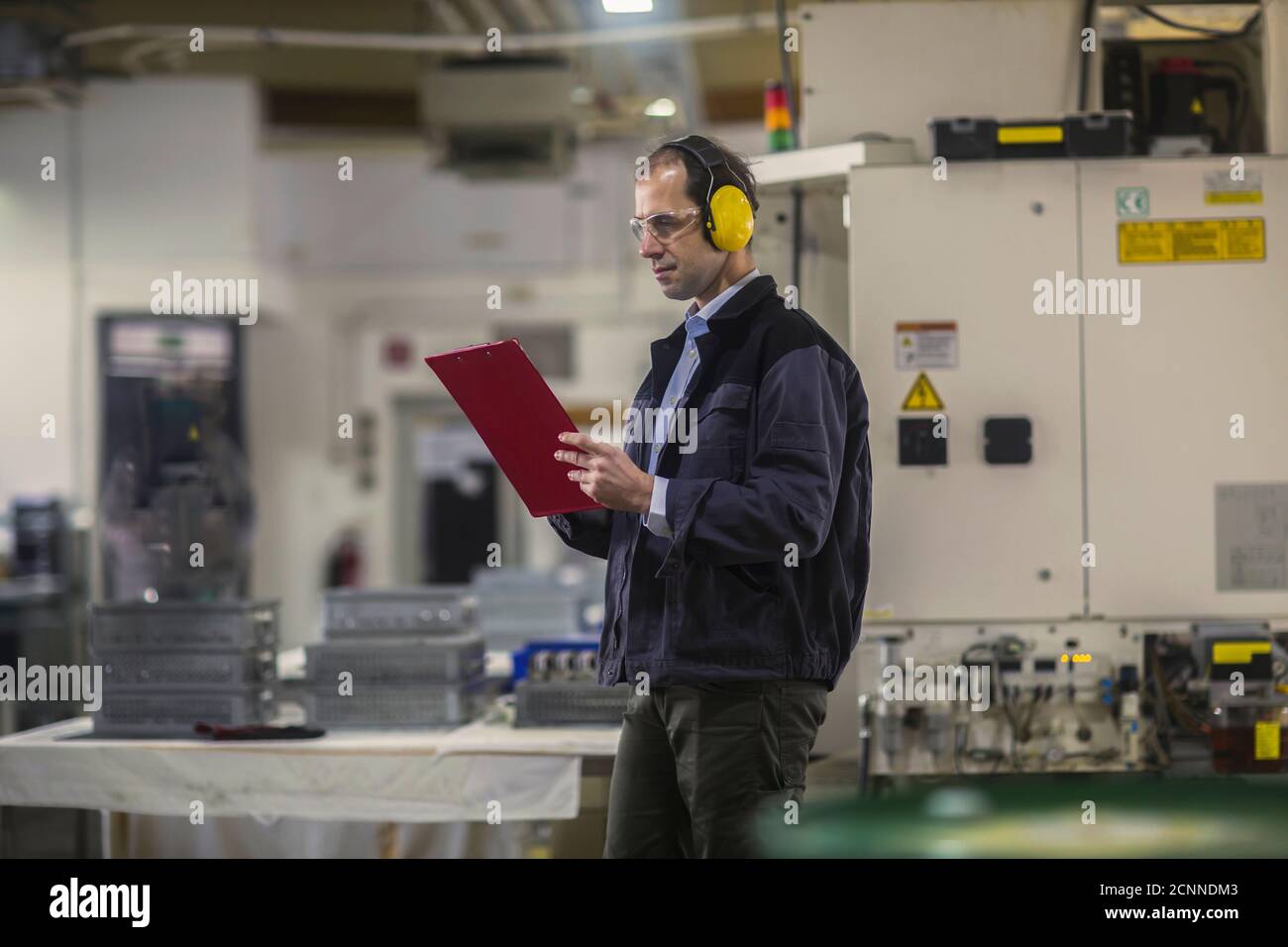 Engineer checking equipment at an industrial plant, Germany Stock Photo ...