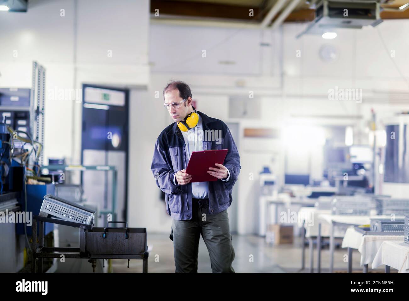 Engineer checking equipment at an industrial plant, Germany Stock Photo ...
