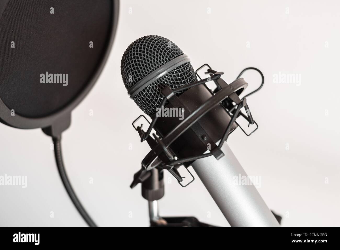 Closeup shot of studio microphone with pop filter isolated on white ...