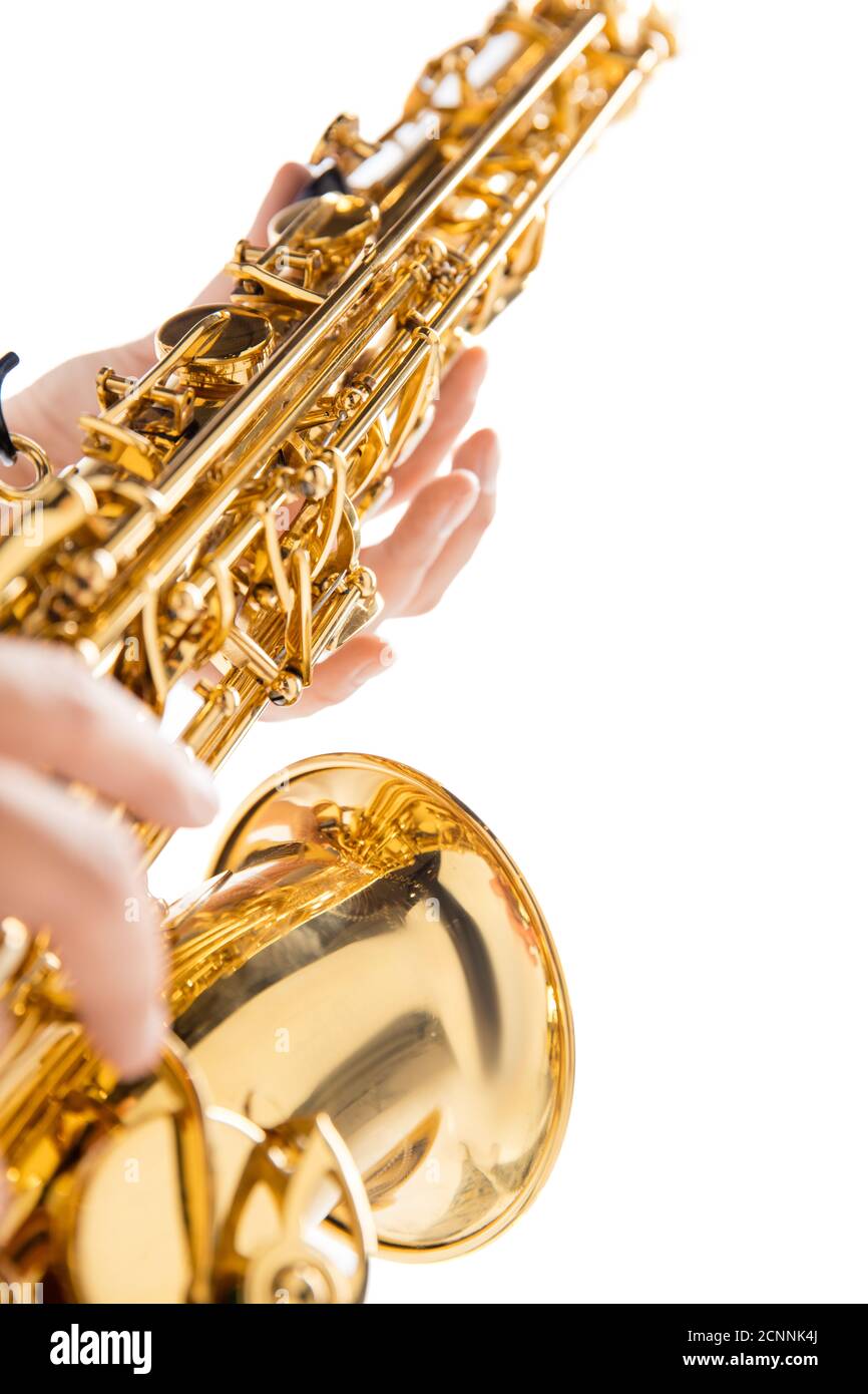 Close up woman playing saxophone isolated on white studio background ...