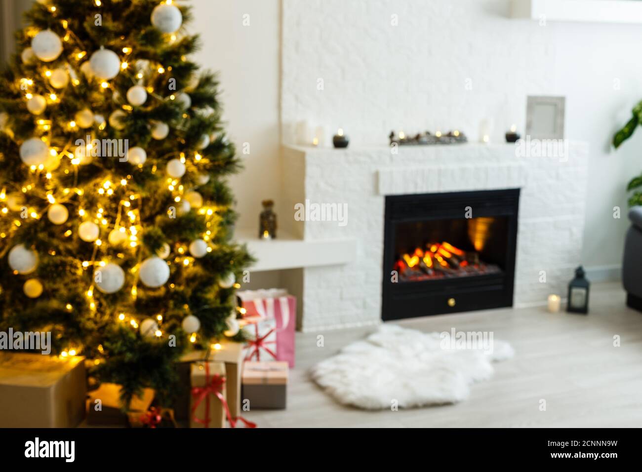 Christmas scene with tree gifts and fire in background Stock Photo - Alamy