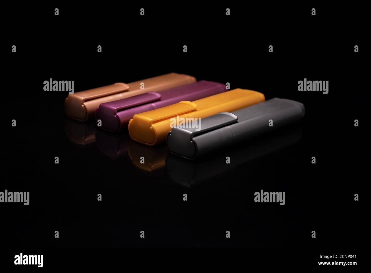 Set of colored markers (silver, gold, ruby and pearl rose) on black ...