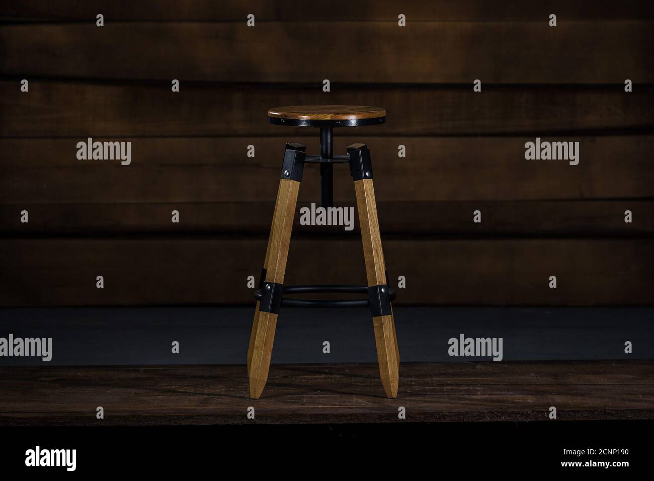 Tall wooden stool in a studio Stock Photo - Alamy