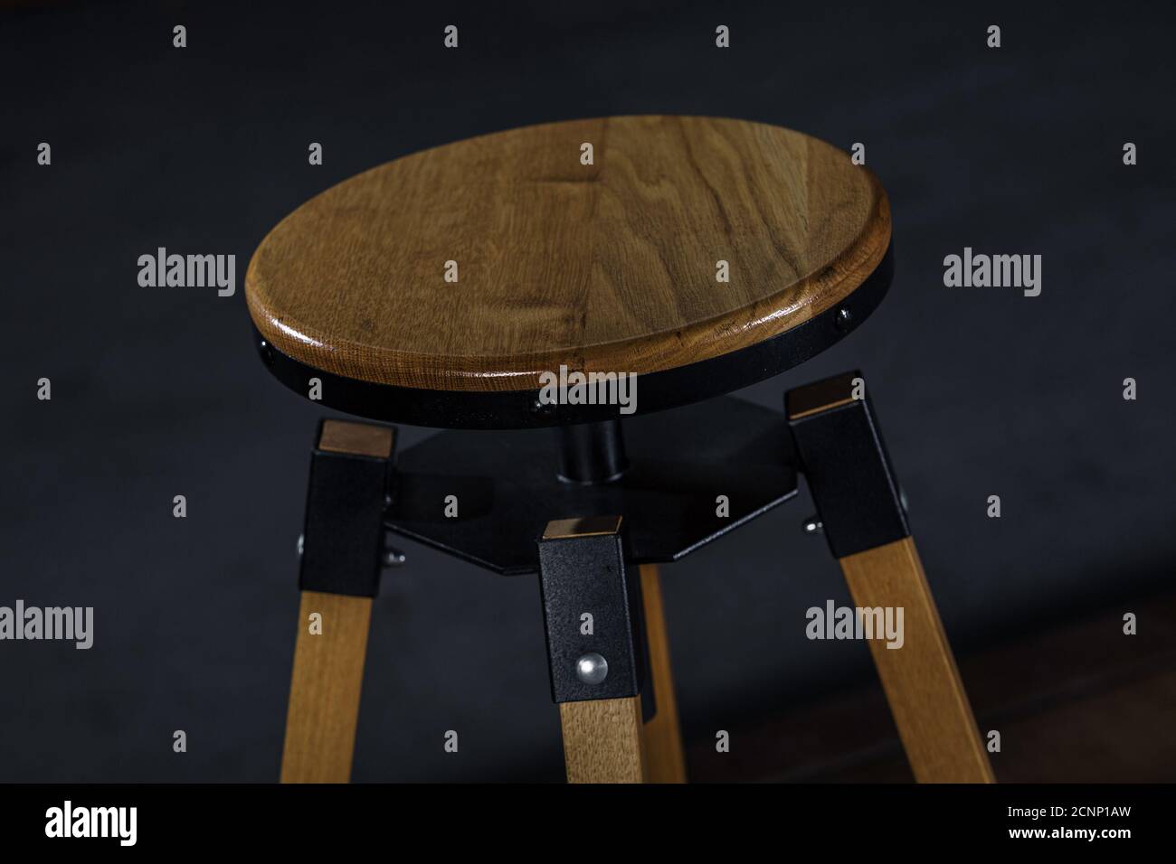 Wooden stool with metal legs in a studio Stock Photo - Alamy