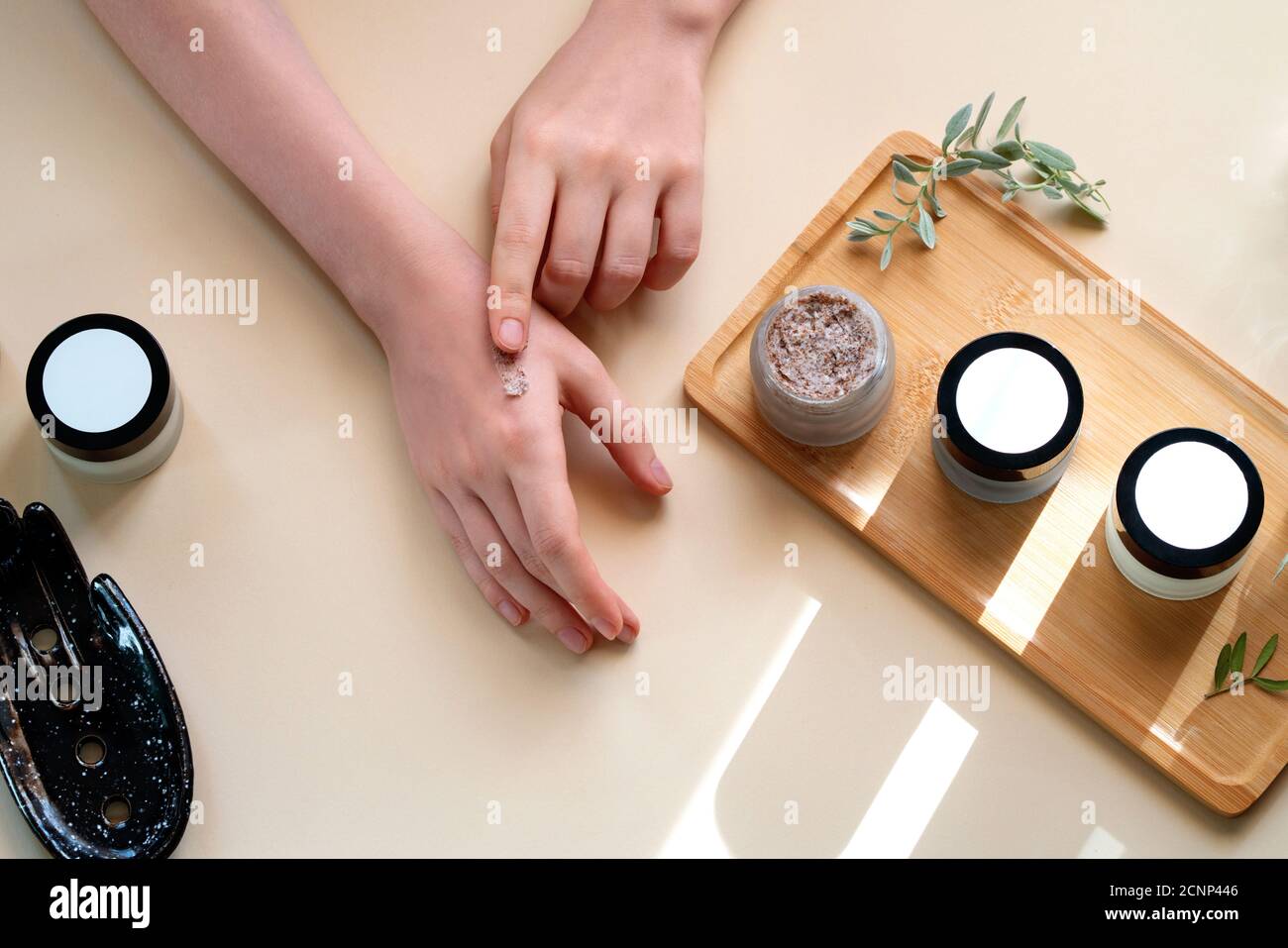 Swatch the scrub on beautiful female hands. Pastel beige background on ...