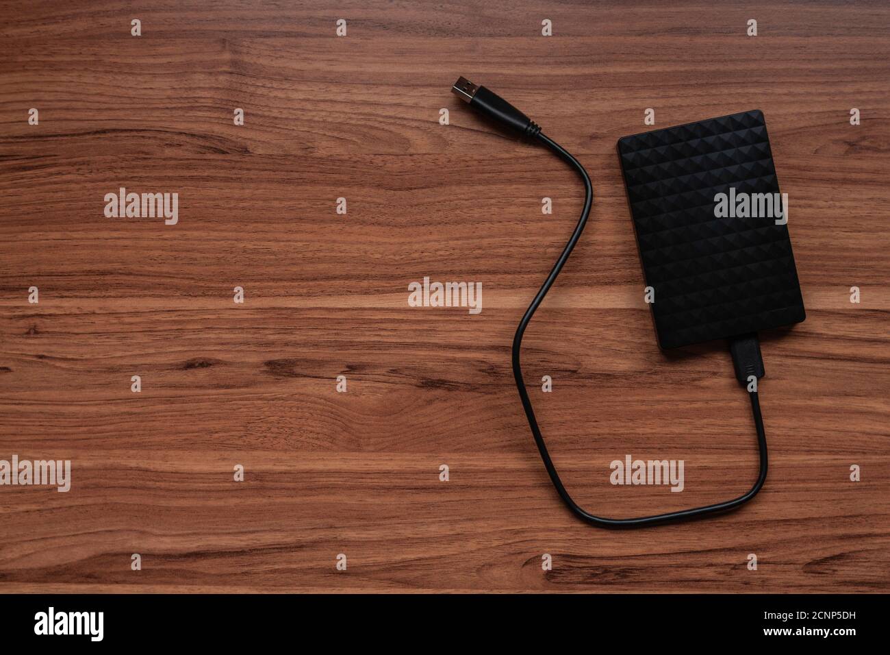 Black external hard drive on wooden background Stock Photo - Alamy