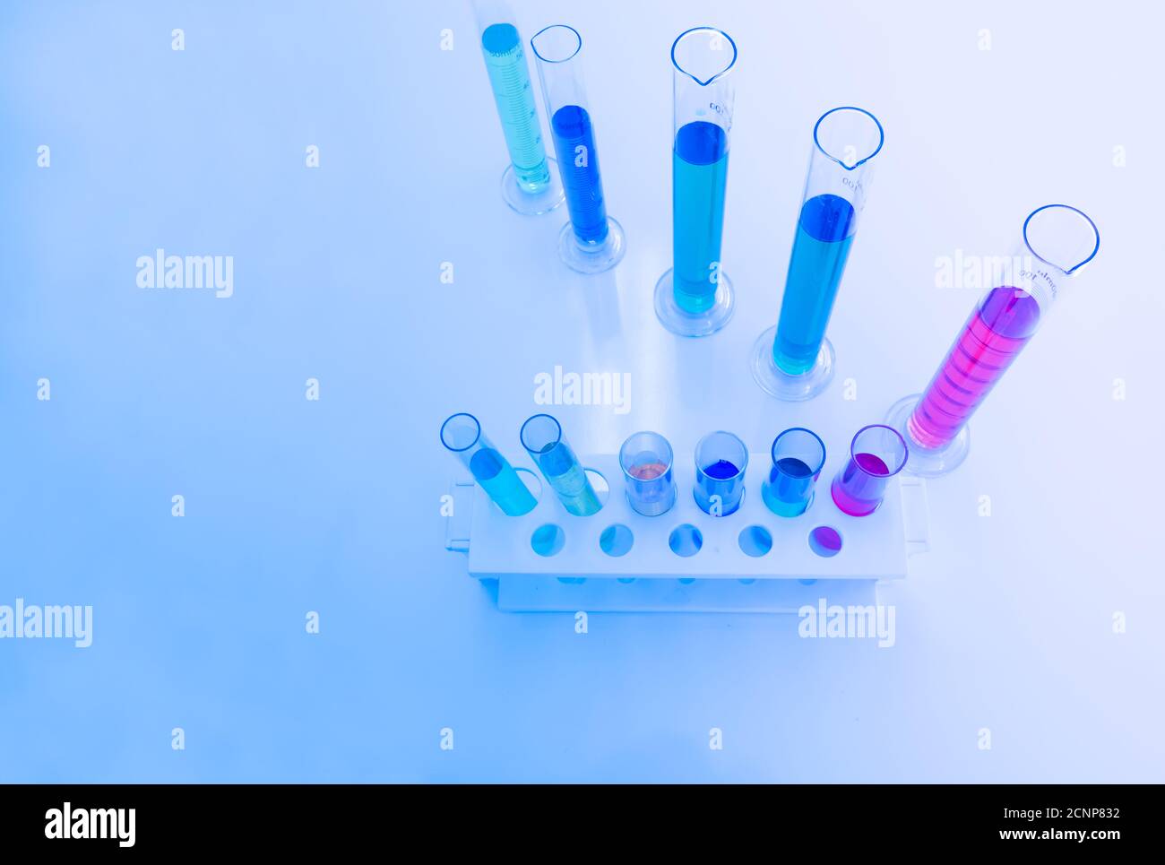The test tube has a multicolored liquid inside. Put on a table for ...