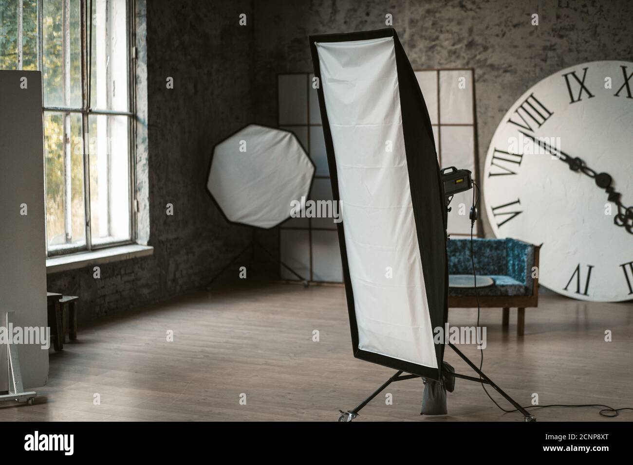 Photo studio with studio light and decorations. In the background is a ...
