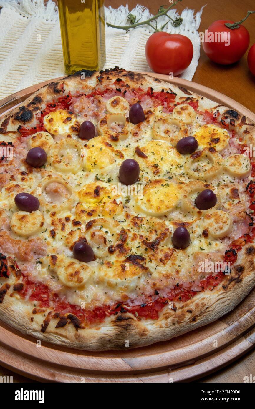 Traditional Portuguese Pizza with egg, olive, palm heart and mozzarela ...
