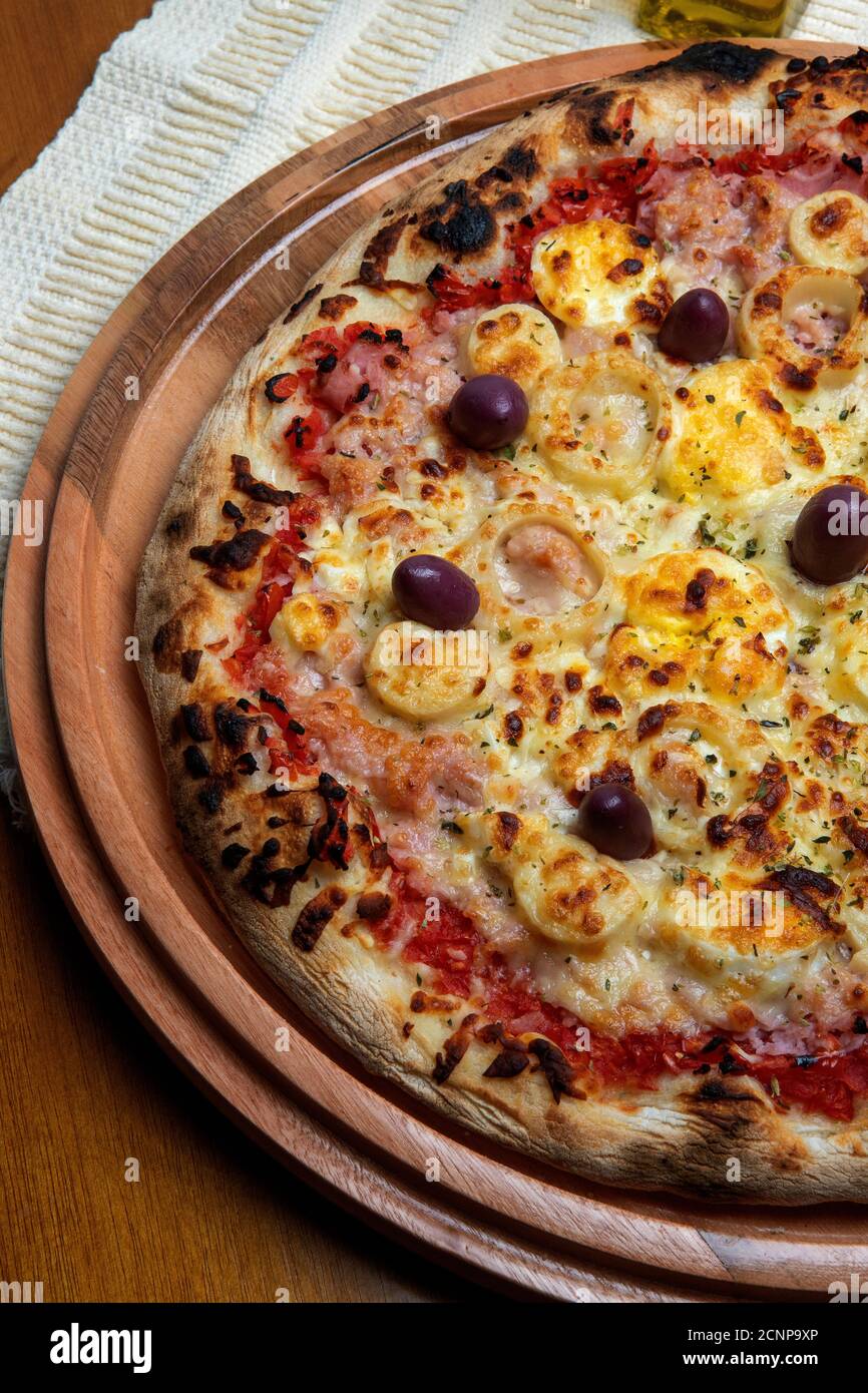 Traditional Portuguese Pizza with egg, olive, palm heart and mozzarela ...