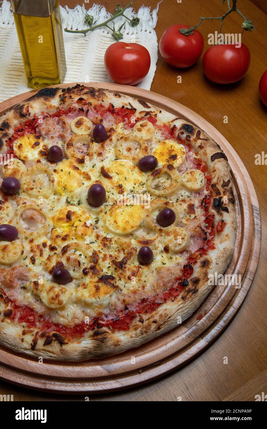 Traditional Portuguese Pizza with egg, olive, palm heart and mozzarela ...