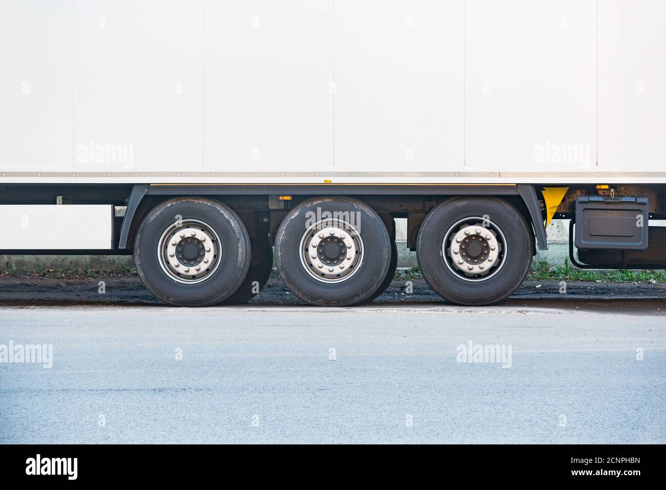 Wheels of the long heavy freight truck Stock Photo - Alamy