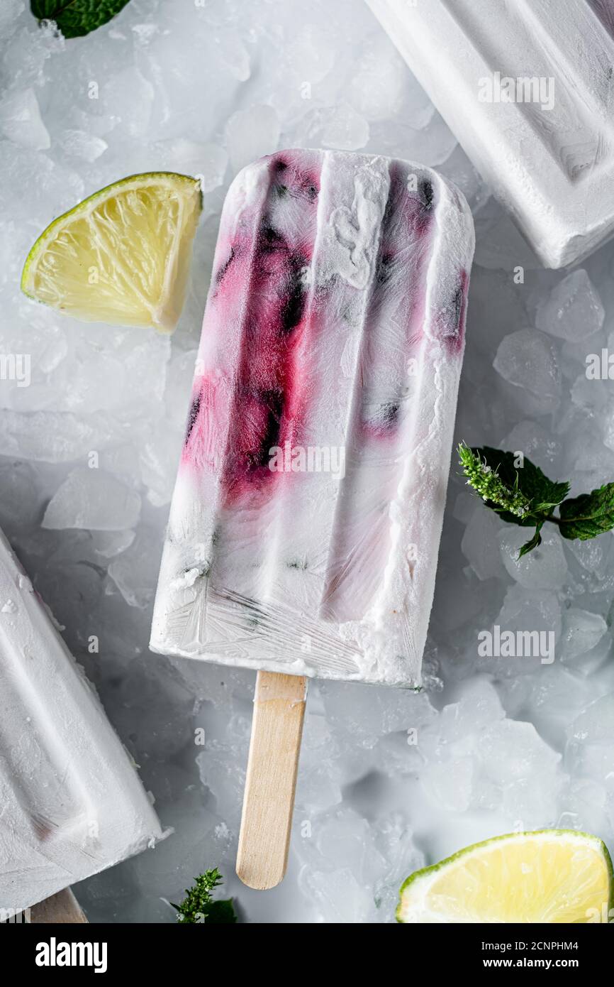Flat lay of a roasted cherry limeade coconut popsicle Stock Photo - Alamy