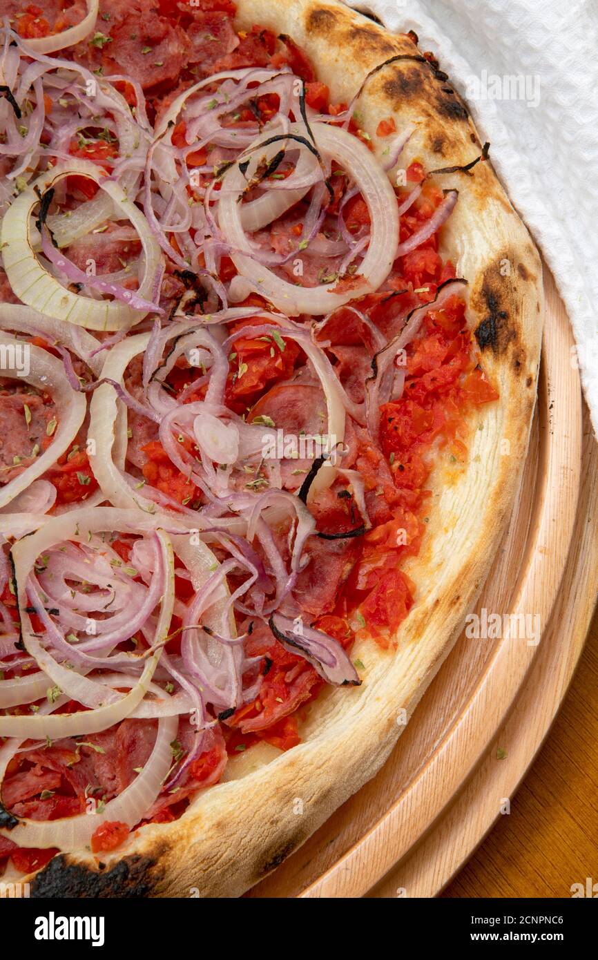 Pizza de Calabresa, Brazilian food. Calabrese sausage pizza with ...