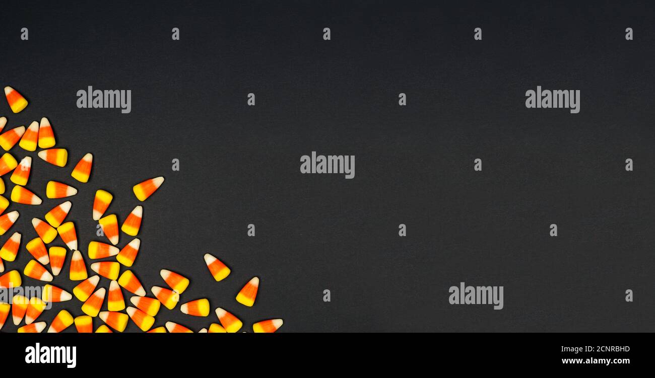 Halloween candy corn corner border banner. Top view on a black ...