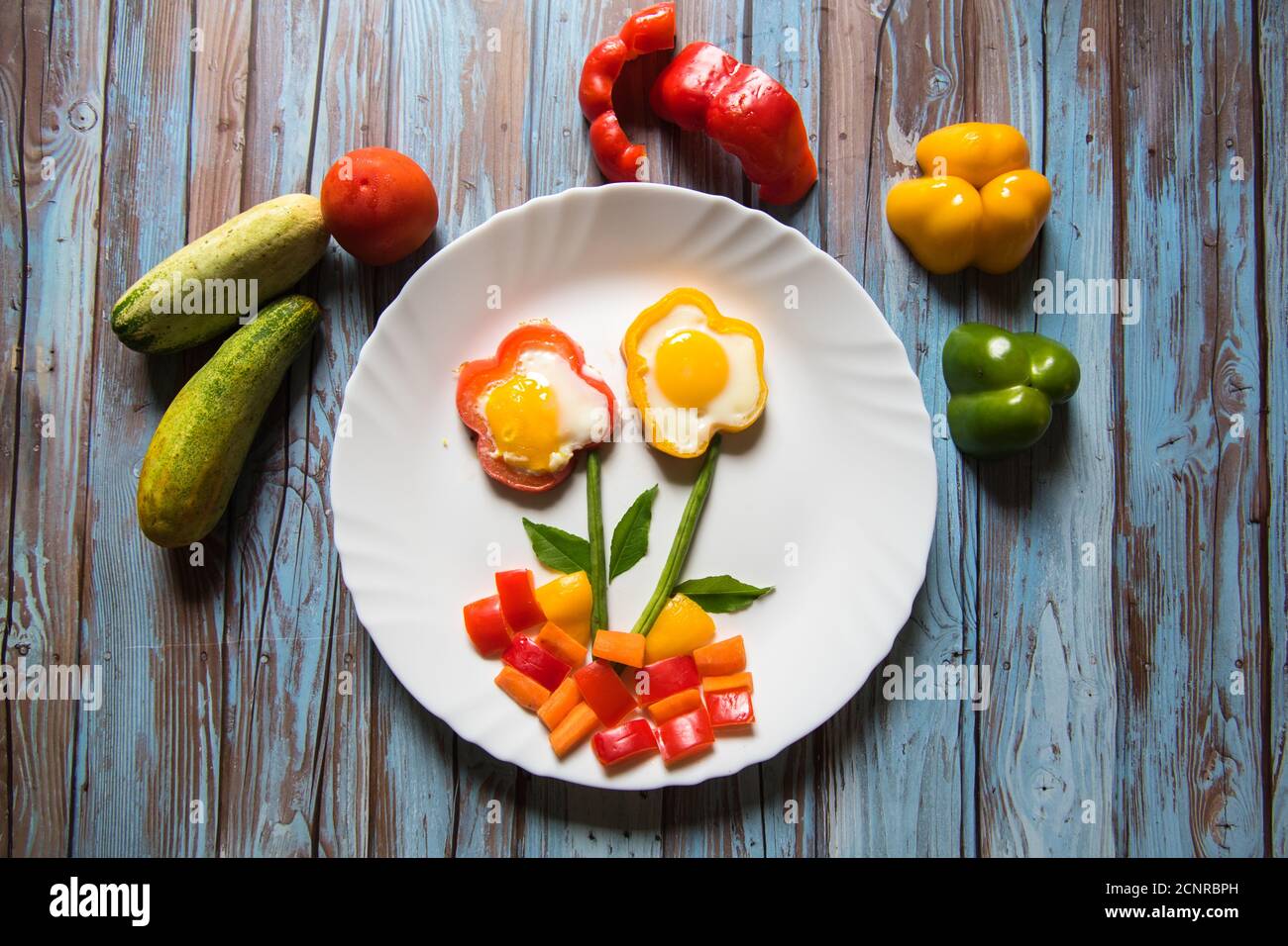 Flower shaped art created with food ingredients along with condiments ...