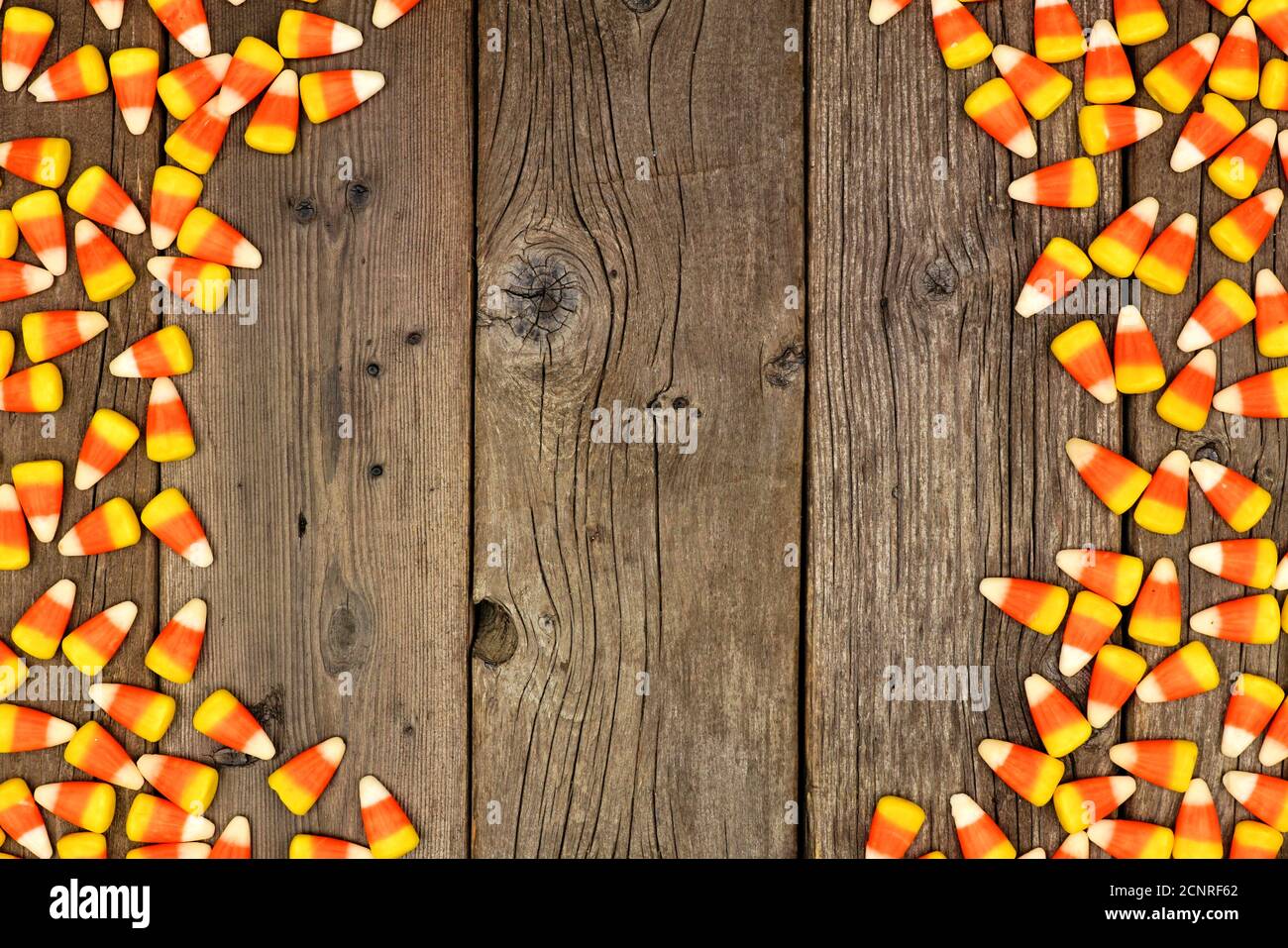 Halloween candy corn double side border. Top view on a rustic wood ...
