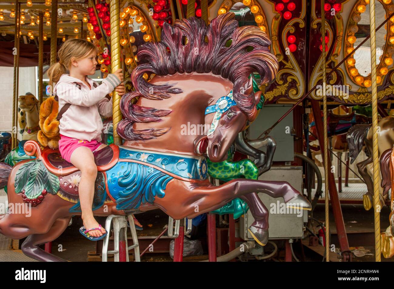 Girl riding on merry go round hi-res stock photography and images - Alamy
