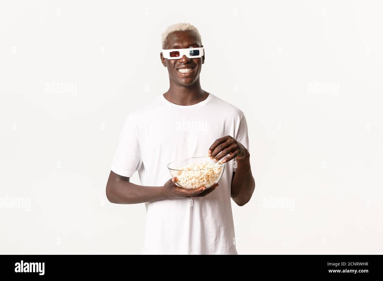Portrait of happy attractive african-american blond guy eating popcorn ...