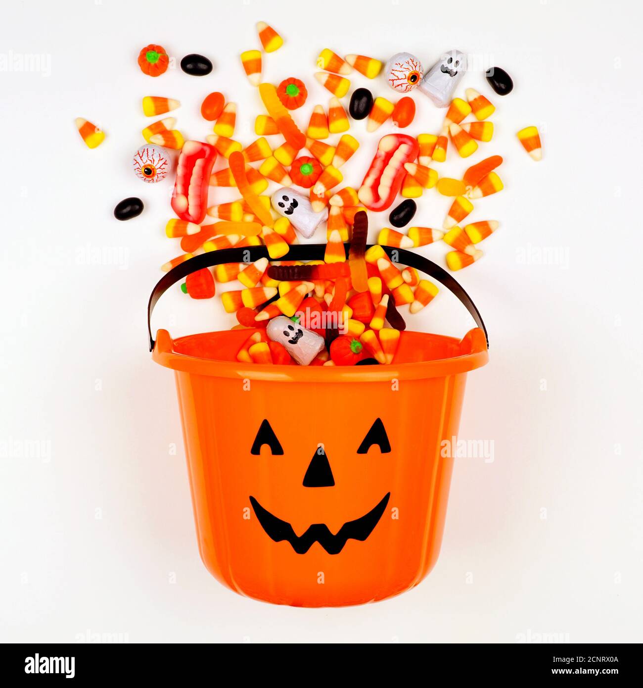 Halloween Jack o Lantern pail with spilling candy, above view on a ...