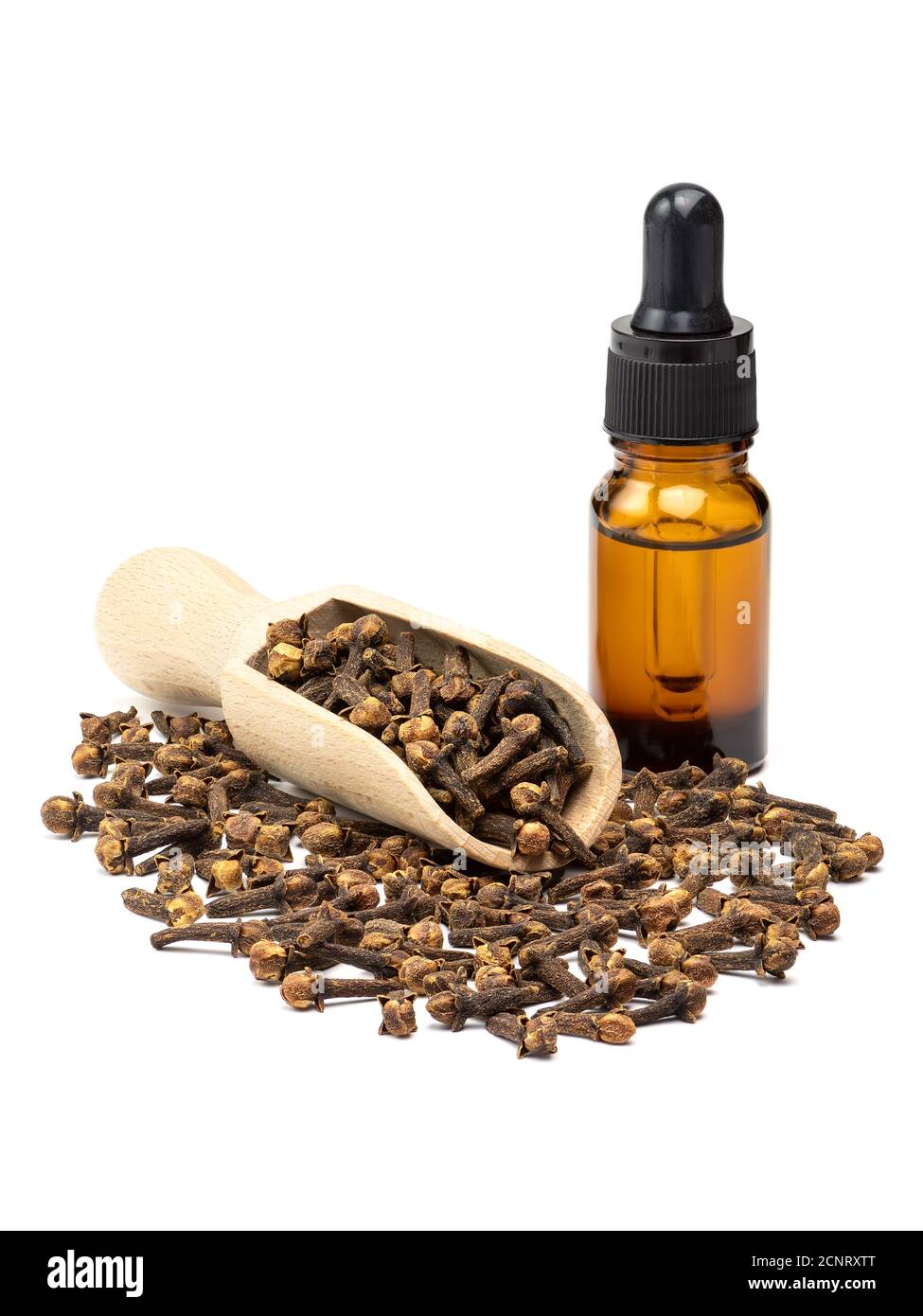 Bottle of clove oil and cloves on wooden spoon hi-res stock photography ...