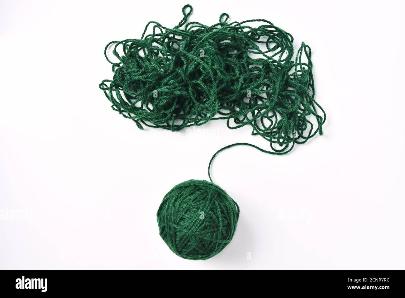 Ball of green thread and tangled threads Stock Photo - Alamy